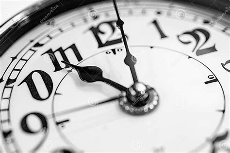 A Close Up Image Showing A Clock With The Hands Pointing To 10 And 12