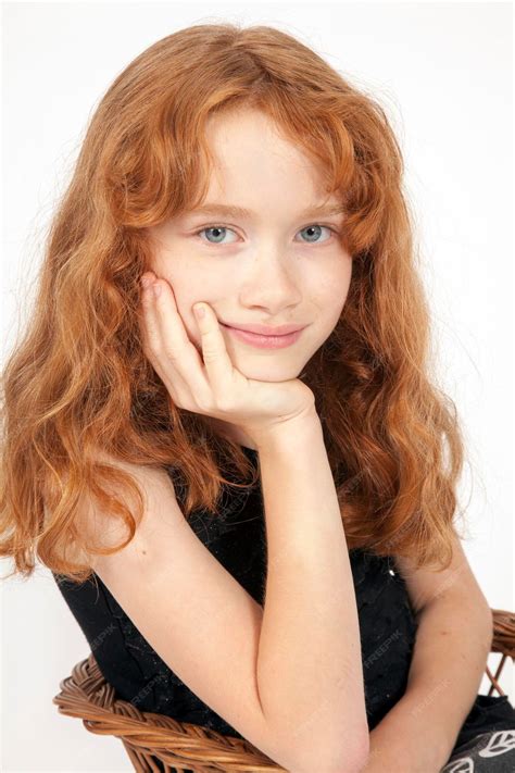Premium Photo Portrait Of Girl Sitting On Chair Against White Background