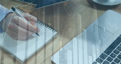 Animation Of Multiple Graphs Overhead View Of Caucasian Man Writing In Notepad On Desk Stock