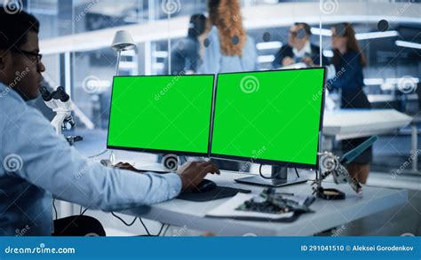 Software Developer Working On Computer With Green Screen Mock Up
