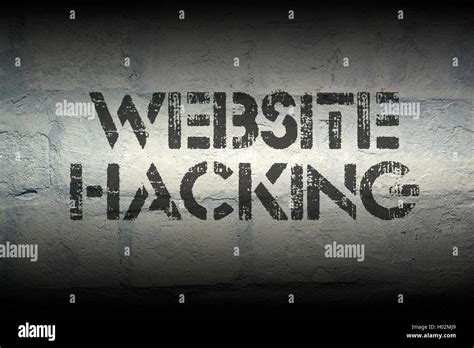 Website Hacking Stencil Print On The Grunge White Brick Wall Stock