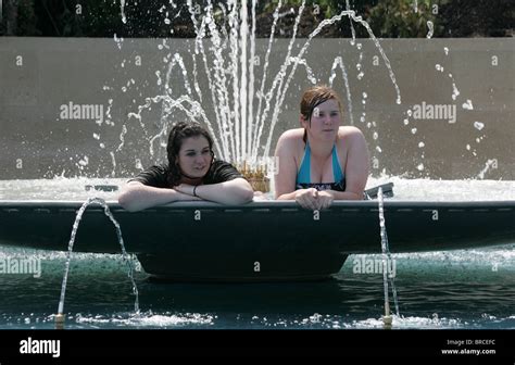 Two Girls Enjoy The Cooling Effect Of This Fountain In Hyde Park