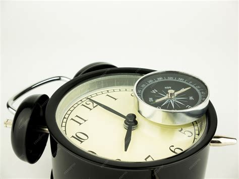 Premium Photo Compass On Alarm Clock