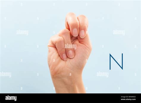 American Sign Language Female Hand Showing Letter N Isolated On Blue