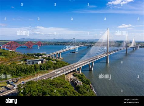 Aerial View Of Three Bridges Crossing The River Forth With New Queensferry Crossing In Front At