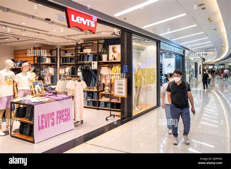 Shoppers Walk Past The American Clothing Company Brand Levis Levis