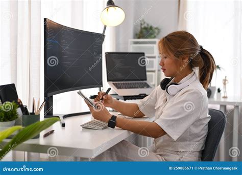 Female Programer Working With Coded Data On Computer Screen And Making