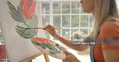 여성 예술가가 아트 스튜디오에서 그림을 그리는 창의적이고 재미 있고 예술적이며 다채롭고 자유와 기쁨 젊은 여성은 실내에서 주말에 혼자 자유 시간과 취미를 즐기며 창조에