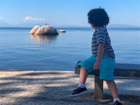 Premium Photo Boy On Beach Against Sky