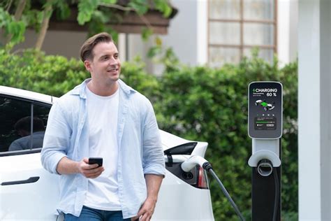 Premium Photo Modern Ecofriendly Man Recharging Electric Vehicle From