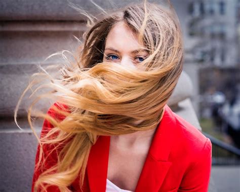 Premium Photo Windy Day Dressing In Red A Young Woman With Long