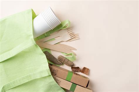 환경 친화적 인 재사용 가능한 녹색 소재 가방에 폐기물 테이블 도자기가 없습니다 베이지 색 배경에 나무 칼과 종이 컵 생태 학적 개념 0명에 대한 스톡 사진 및 기타 이미지