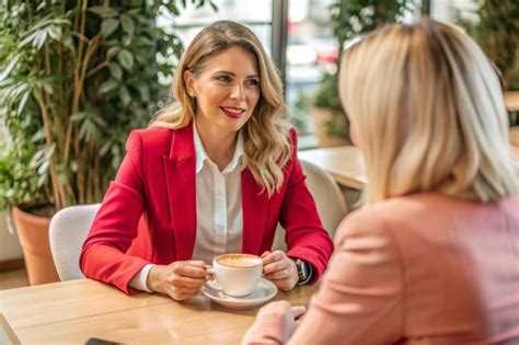 A Woman Business Advisor In A Businesscasual Outfit Sitting Across From A Client Premium Ai