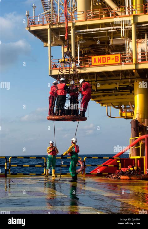 Offshore Worker Transfer From Platform To Vessel By Using Crane Stock