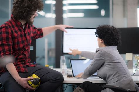 Premium Photo Young Software Developers Couple Using Laptop And Desktop Computer While Writing