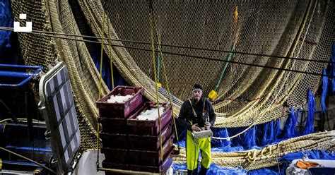 검은 재킷과 녹색 바지를 입은 남자가 빨간색과 검은색 플라스틱 상자 옆에 서 있다 사진 Unsplash의 무료 배 이미지