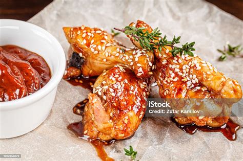 매운 칠리 소스와 참깨와 아시아 요리 글레이즈 프라이드 닭 다리 흰색 양피지에 레스토랑에서 요리를 제공합니다 배경 이미지 복사 공간 텍스트 건강한 식생활에 대한 스톡 사진