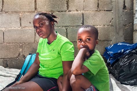 Holdjy 5 And His Mother Sit In Their Makeshift Tent At A Displacement