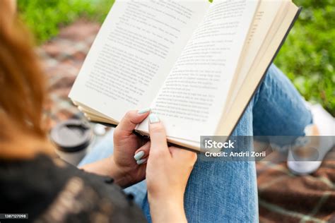 청바지를 입고 커피 한 잔을 들고 공원의 담요에 앉아있는 여성 Brand Name Smart Phone에 대한 스톡 사진 및 기타 이미지 Brand Name Smart