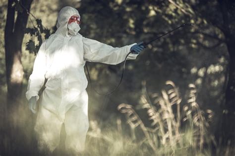Premium Photo A Worker Sprays Pesticides On Trees Outdoors Tree Pest