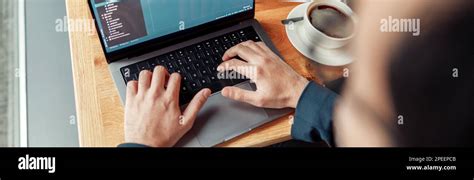 Back View Of Developer Programmer Freelancer Working On Project In Cafe Blurred Background