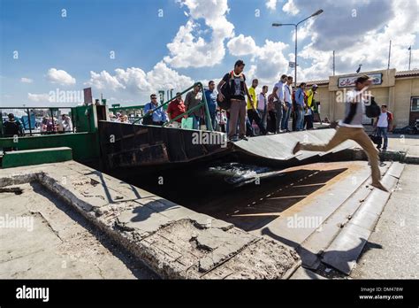 Passengers Leaving The Free Ferry On The Suez Canal Linking Port Fuad To Port Said Egypt Stock
