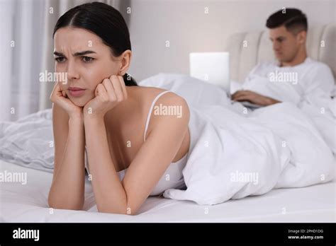 Internet Addiction Man With Laptop Ignoring His Girlfriend In Bedroom
