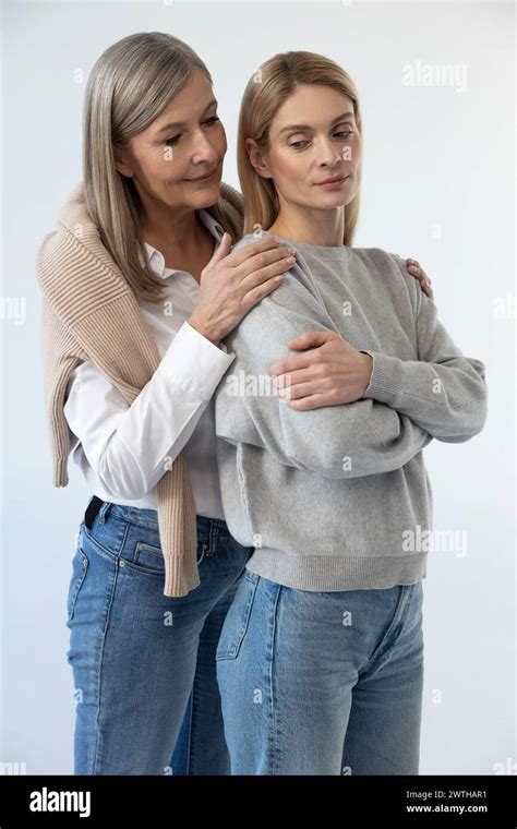 Gray Haired Good Looking Woman Hugging Her Daughter With Tenderness