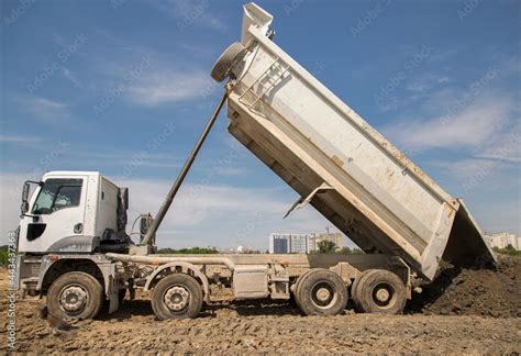 Dump Truck At Work At A Construction Site The Process Of Transporting