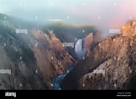 Sunrise At The Lower Falls Of The Yellowstone River And Grand Canyon