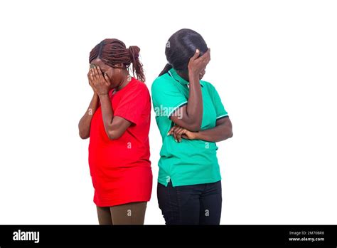Portrait Of Two Beautiful Desperate Mature Women Covering Their Faces With Their Hands Stock