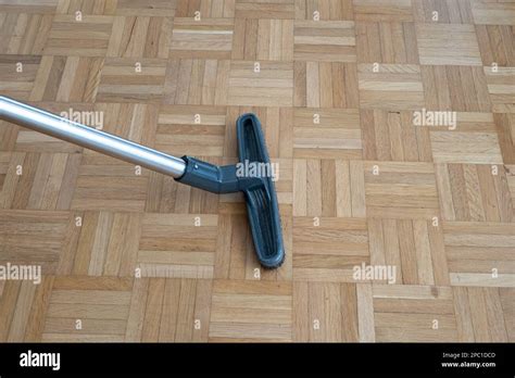 Household Vacuum Cleaner Brush And Extension Rod On Laminated Wooden