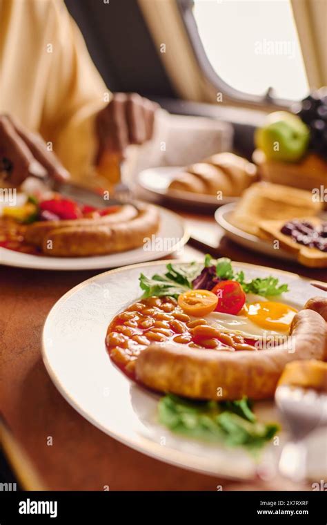 An Interracial Couple Enjoys A Delectable Meal In A Cozy Camper Van