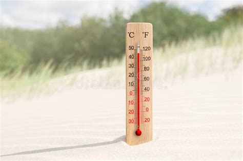Wooden Celsius And Fahrenheit Scale Thermometer In The Sand Air Temperature Plus 46 Stock Image