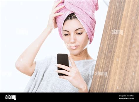 In Her Luminous And Exceptionally Spacious Home A Young Woman With A Towel Wrapped Around Her