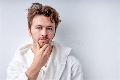 Good Looking Young Man Admiring Touching Face Looking At Camera
