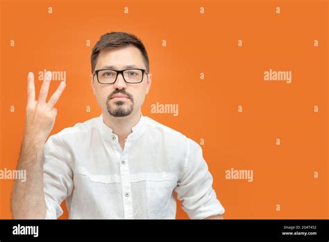 Handsome Serious Confident Business Man Wearing Nerd Glasses Over Orange Background Showing And