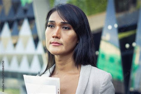 Thai Woman Portrait With Hopeless Look Holding Files Folder Outside Office Building Worried