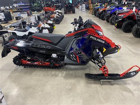 2025 Polaris® 9r Indy Xcr 128 Midnight Blue Metallic Indy Red Ride North Michigan And