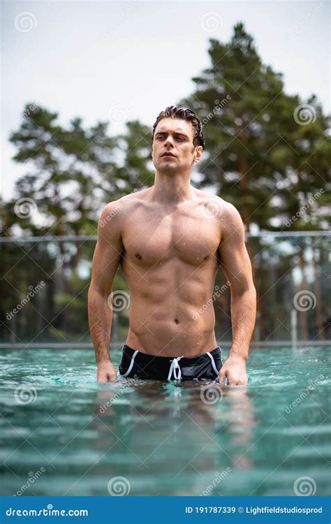 Focus Of Shirtless And Wet Man Standing In Swimming Pool Stock Image Image Of Relax