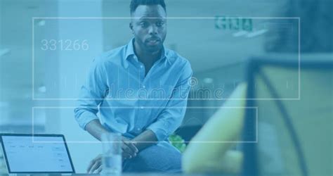 Image Of Data Processing Over Diverse Man And Woman Discussing Over A Laptop At Office Stock