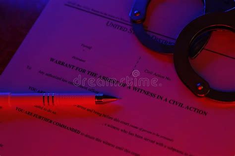 District Court Warrant For The Arrest Of A Witness In A Civil Action Papers With Handcuffs And