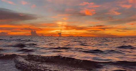 A Sunset Over The Ocean With Clouds And Waves Free Stock Video Footage