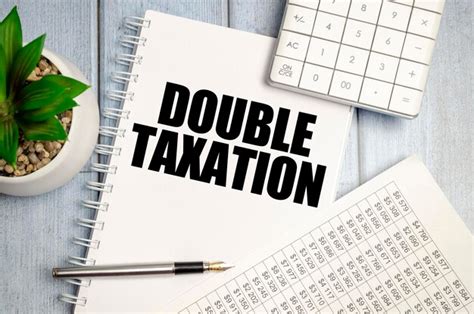 Premium Photo Double Taxation Word On Notepad With Glasses And Chart