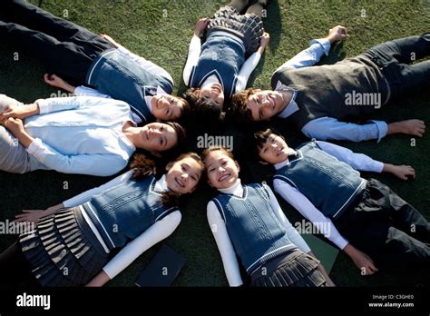 Teacher And Babes Lying In A Circle On Grass Stock Photo Alamy