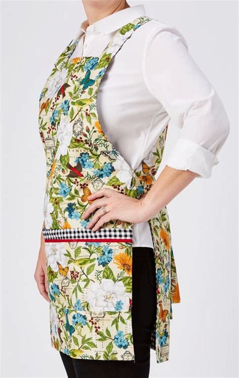 A Woman Wearing An Apron With Flowers On It