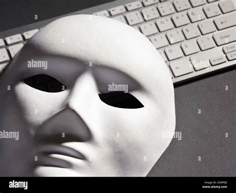 White Face Mask And Computer Keyboard On Black Background Hacker