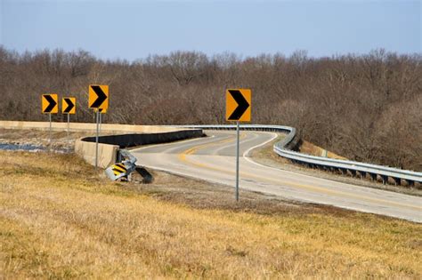 Premium Photo Arrow Symbols On Empty Road Against Clear Sky