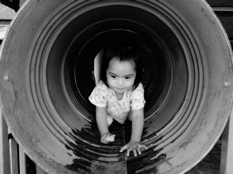 Premium Photo Cute Girl Crawling In Empty Drum