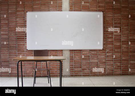 Empty Teacher`s Desk With Whiteboard In The Background No Teacher No